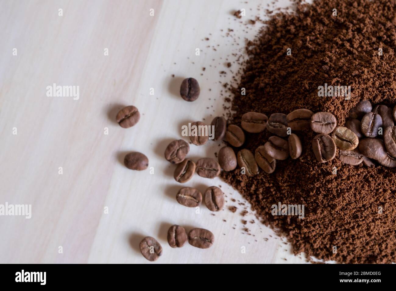 Top view of coffee beans and ground coffee on wooden background ...
