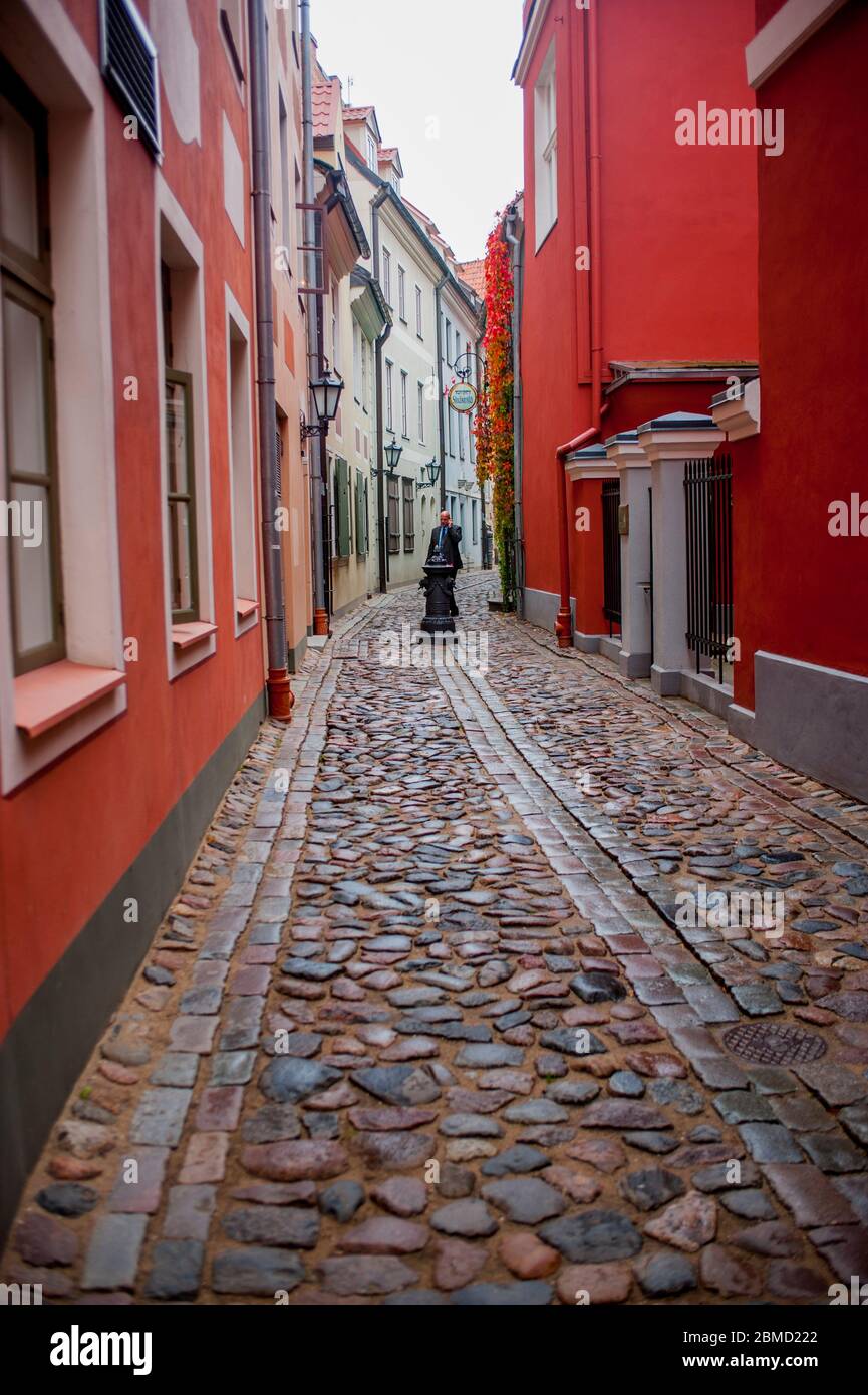 A narrow alley with a cobblestone street in Riga, Latvia Stock Photo ...