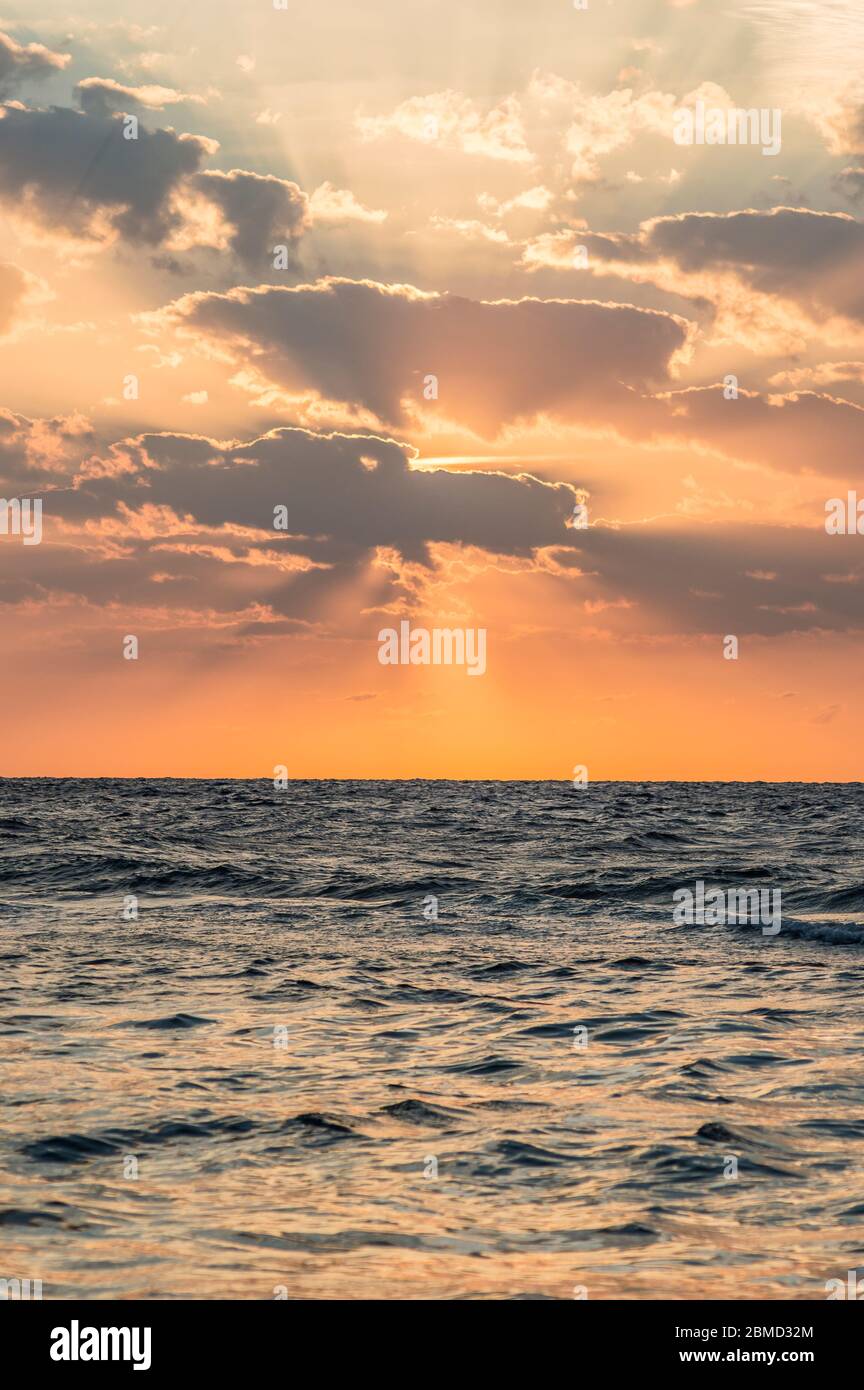 Golden hour of sunset at red sea shore with dramatic sky and the golden ...