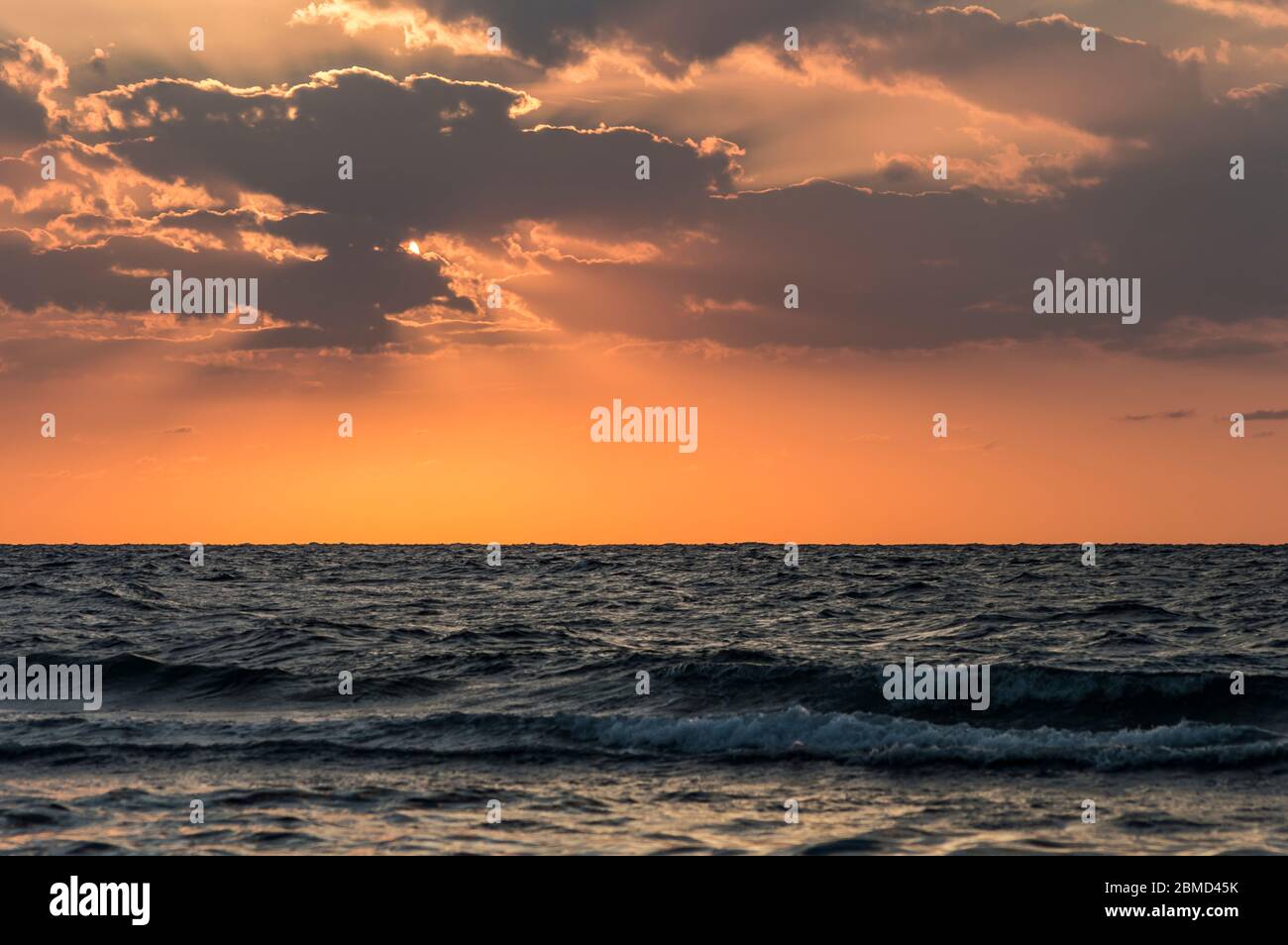 Golden hour of sunset at red sea shore with dramatic sky and the golden ...
