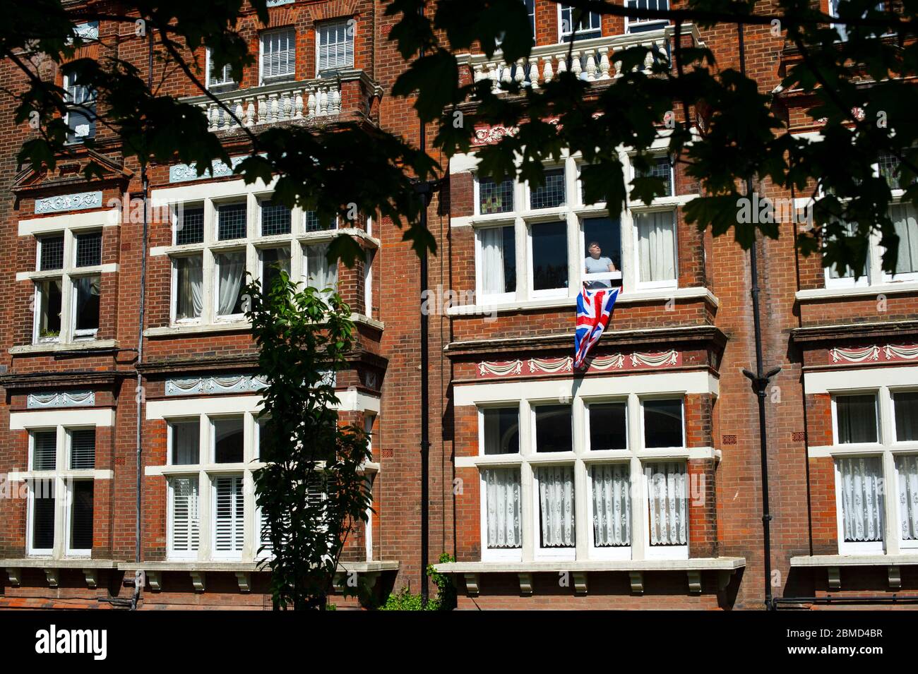 Union Jack flag hanging from a house window Stock Photo - Alamy