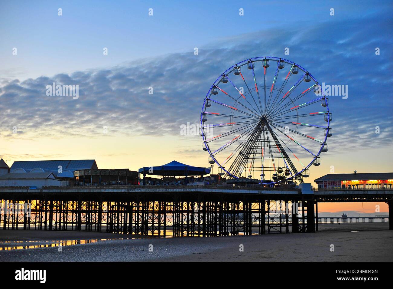 The Ferris wheel on Central Pier in Blackpool shines in red white and ...