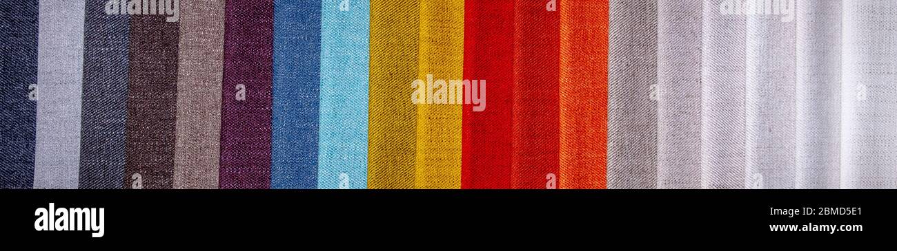 Rainbow clothes background. Pile of bright folded clothes Stock Photo ...