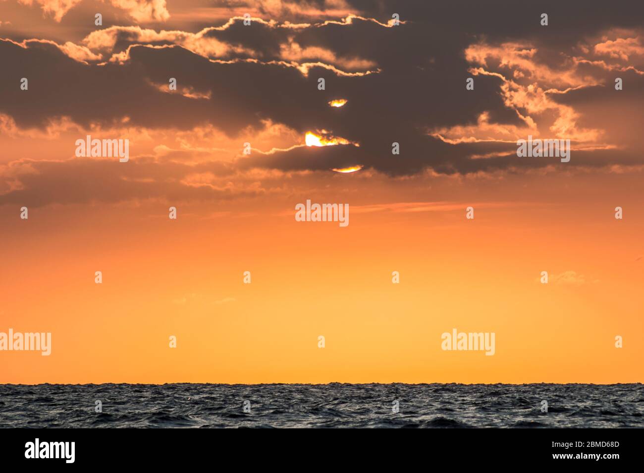 Golden hour of sunset at red sea shore with dramatic sky and the golden ...