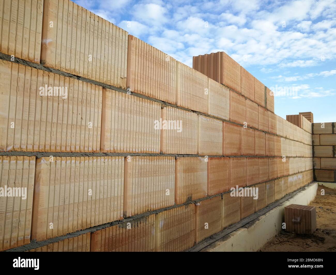 Unfinished construction wall build from ceramic blocks in construction ...