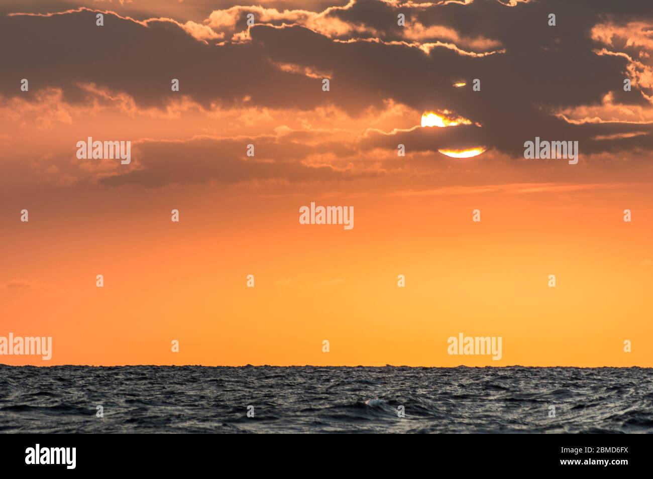 Golden hour of sunset at red sea shore with dramatic sky and the golden ...