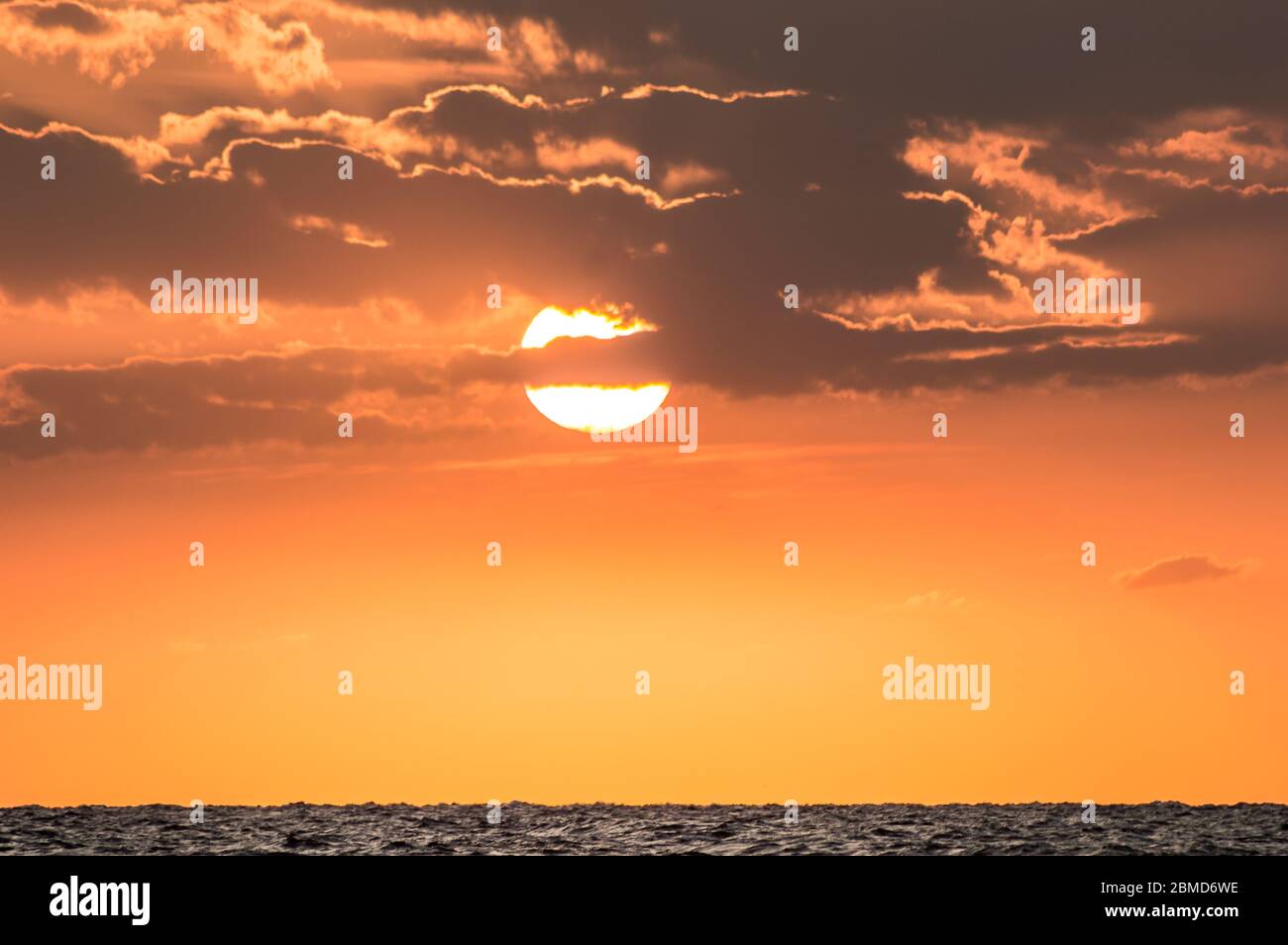 Golden hour of sunset at red sea shore with dramatic sky and the golden ...