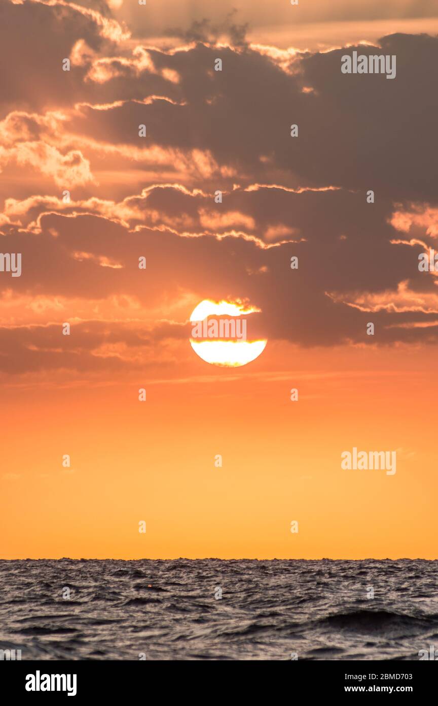 Golden hour of sunset at red sea shore with dramatic sky and the golden ...