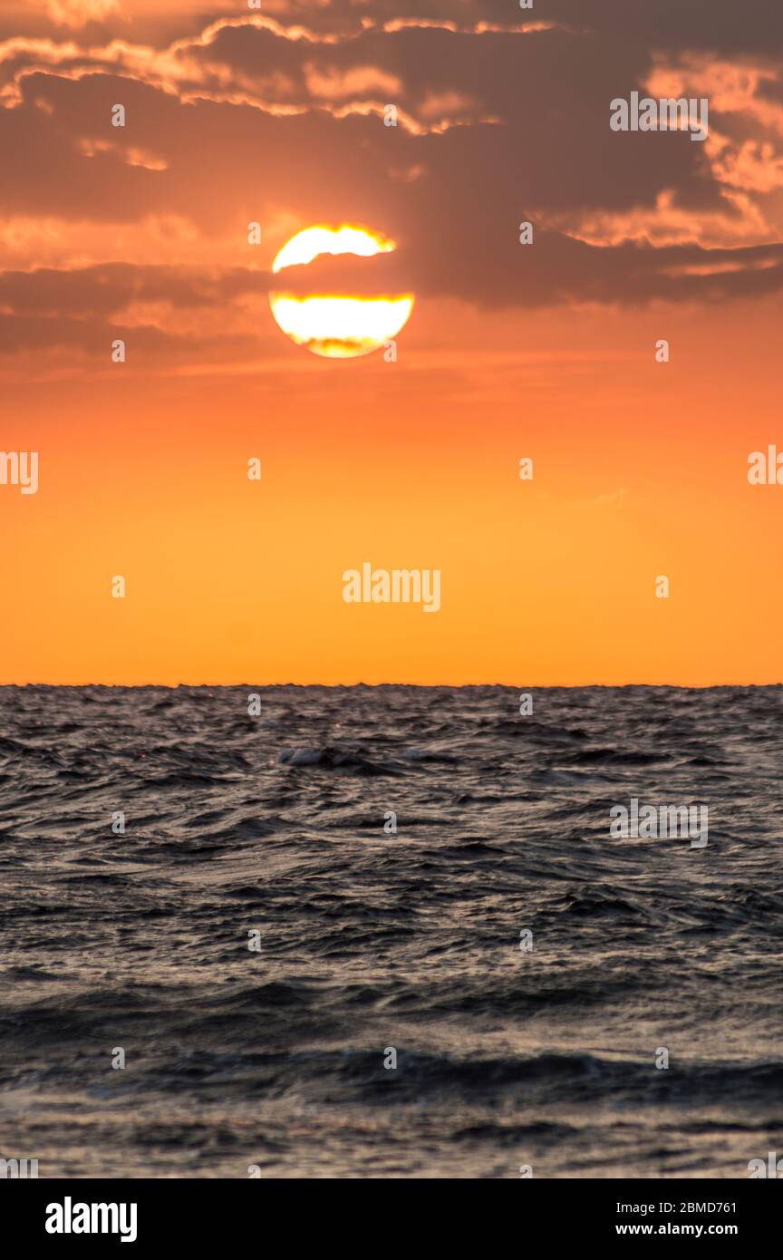 Golden hour of sunset at red sea shore with dramatic sky and the golden ...