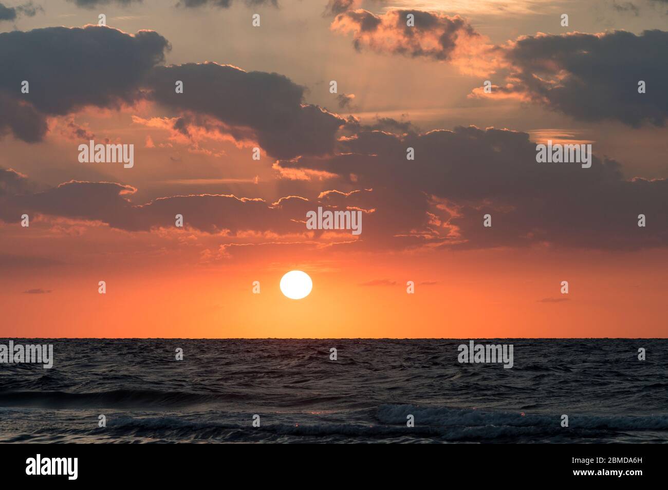 Golden hour of sunset at red sea shore with dramatic sky and the golden ...