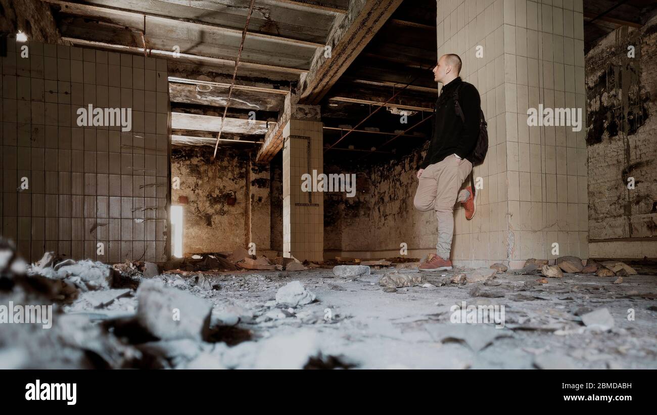 Young man inside ruined and abandoned old factory interior Stock Photo ...