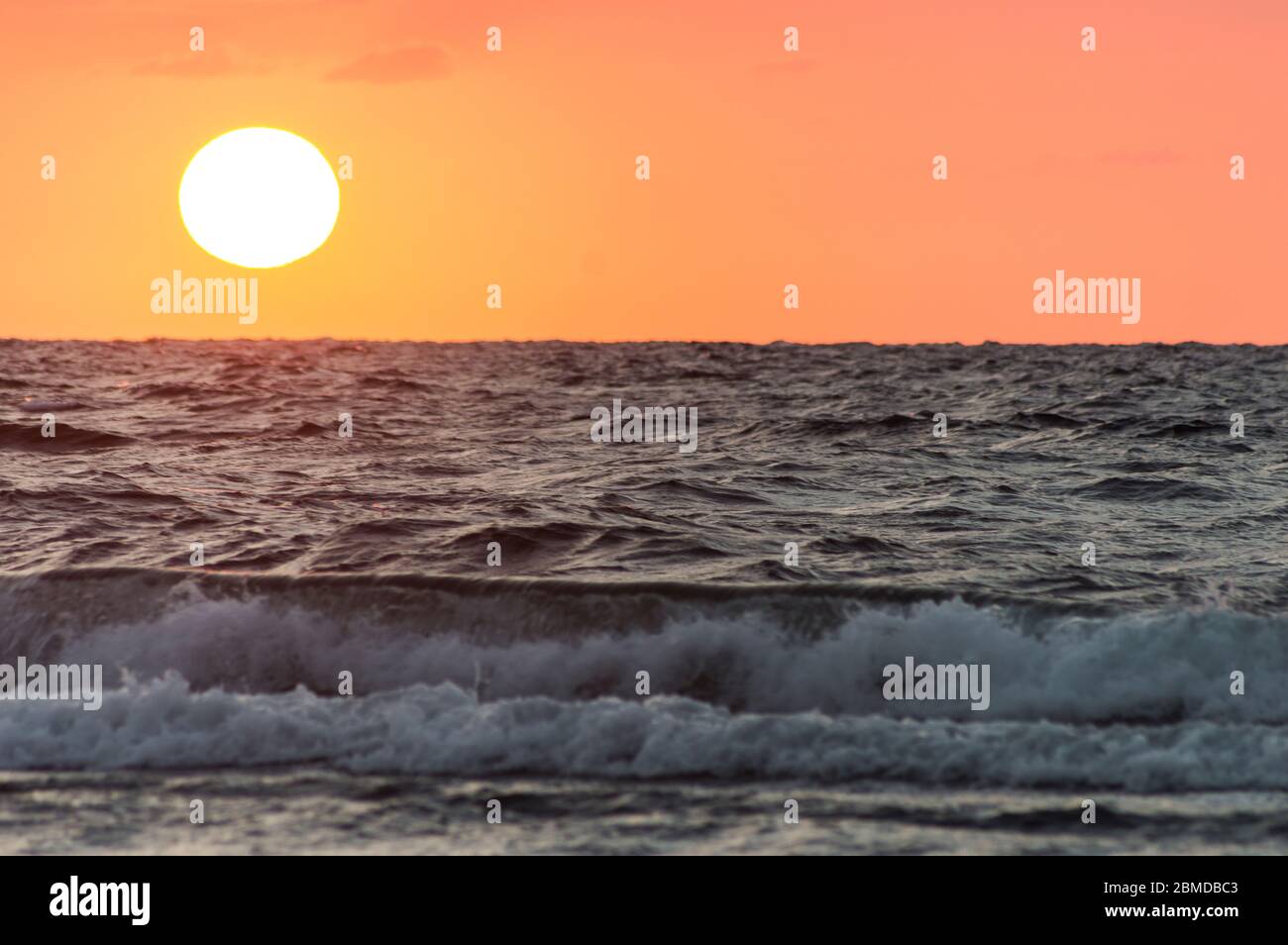 Golden hour of sunset at red sea shore with dramatic sky and the golden ...