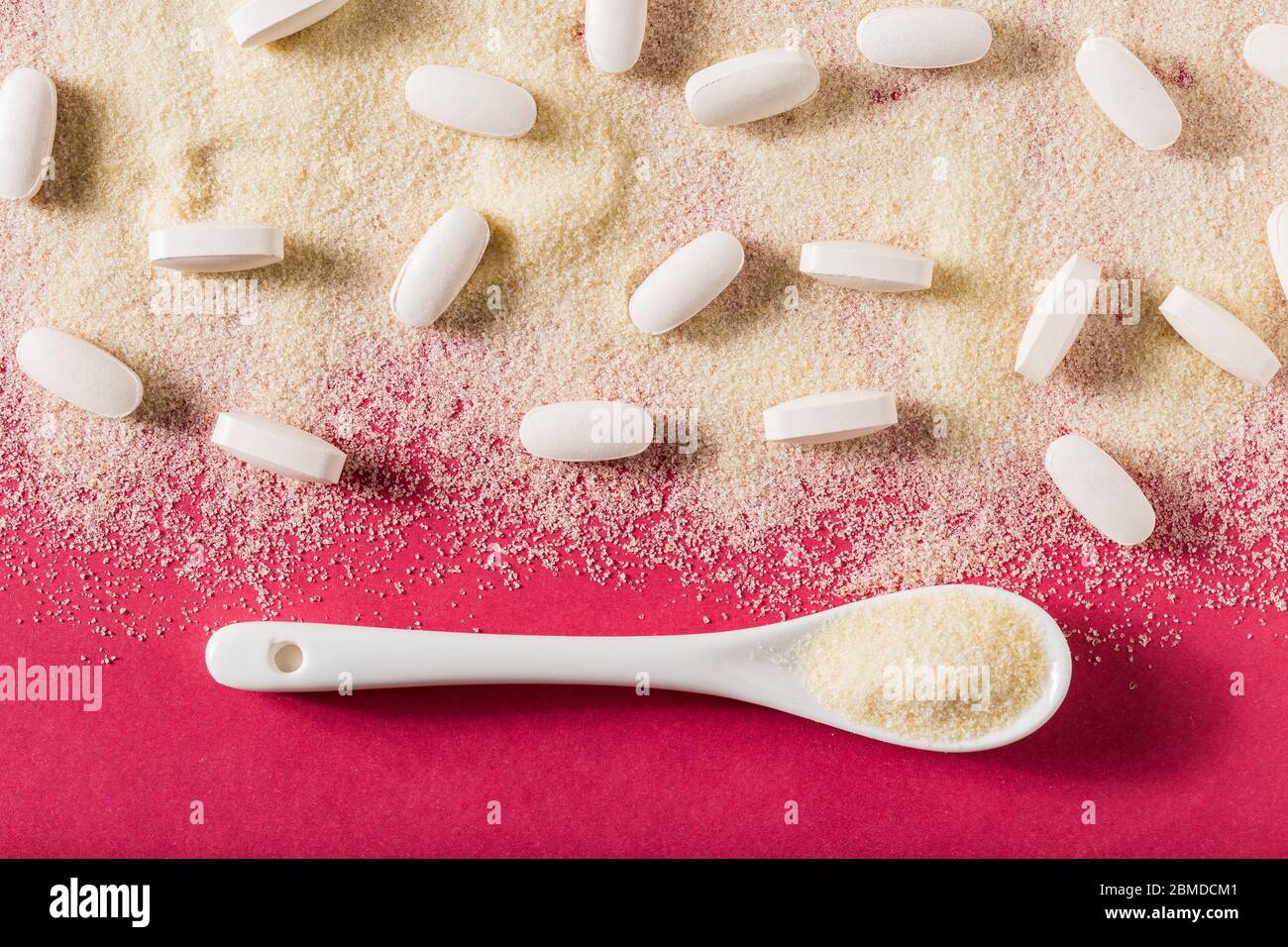 Hydrolyzed and co-compressed collagen, on pink background, top view ...