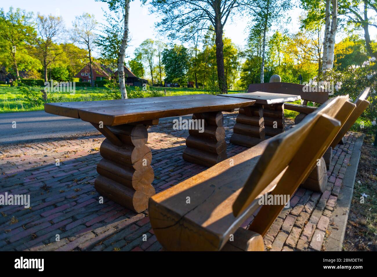 on a country road far away from cities there are wooden benches and ...