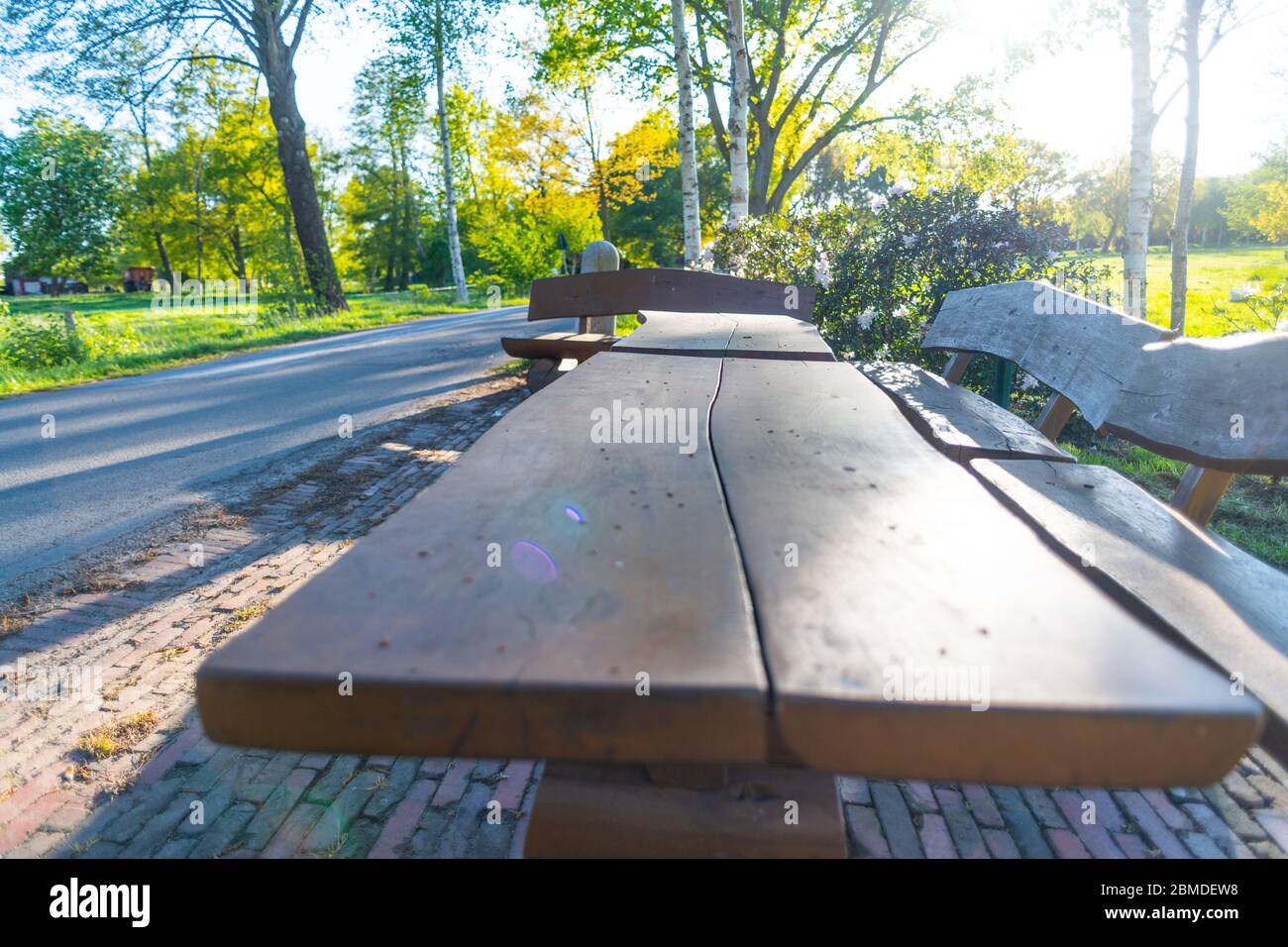 on a country road far away from cities there are wooden benches and ...