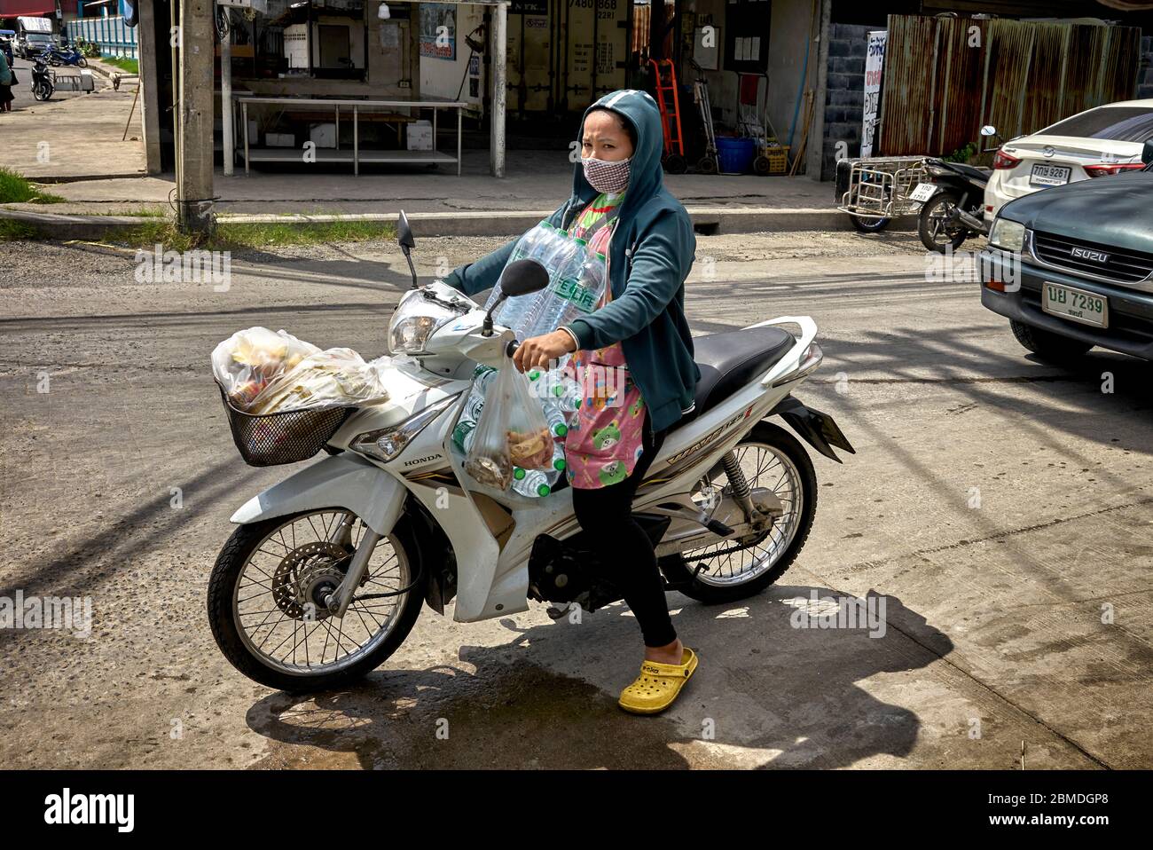 Woman carrying shopping load on a motorcycle. Thailand, Southeast Asia ...