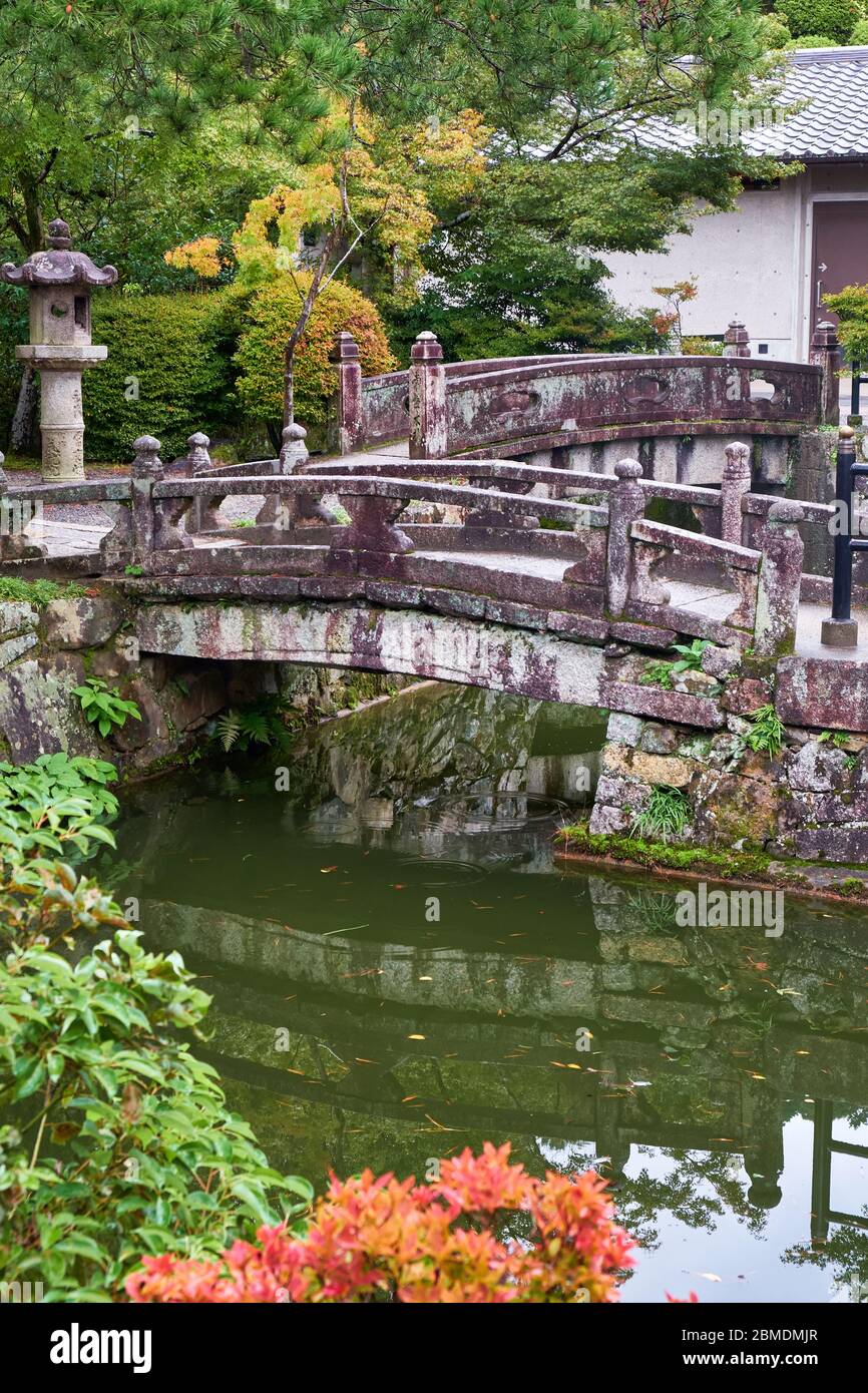 The stone bridges over the watercourse to the small shrine on the ...