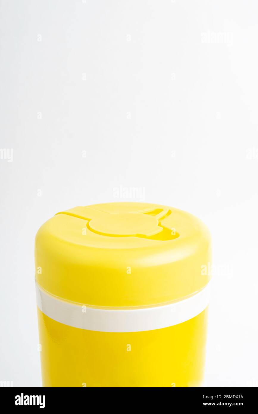 A macro shot of a closed yellow push top cap of a disinfectant wet ...