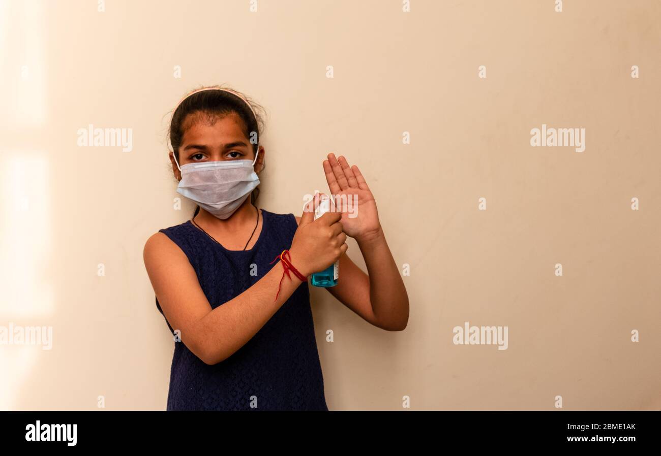 Young girl using sanitizer to safe herself from Germs Stock Photo - Alamy