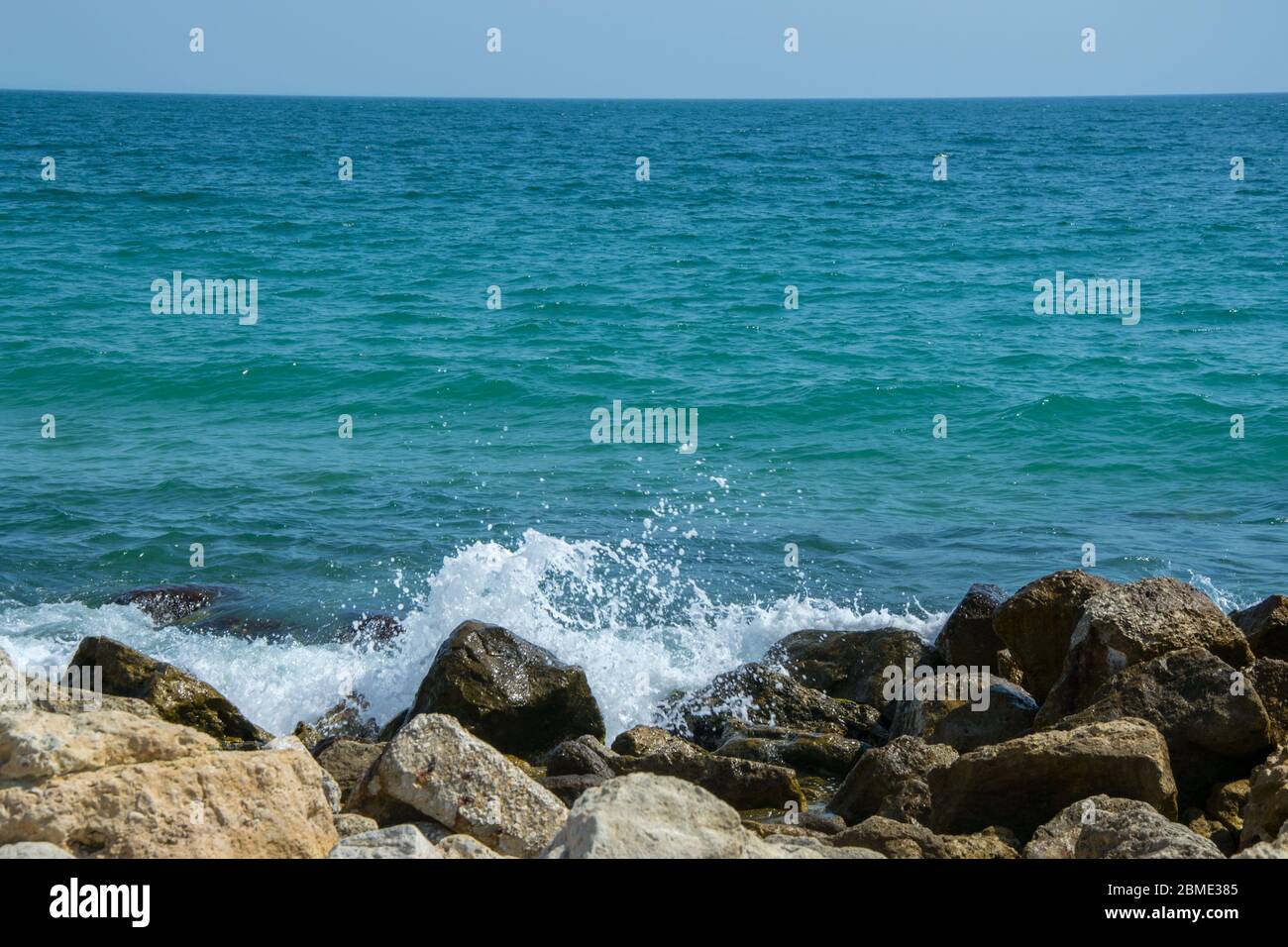 Beautiful wild beach landscape, sunny day, water waves hitting the ...