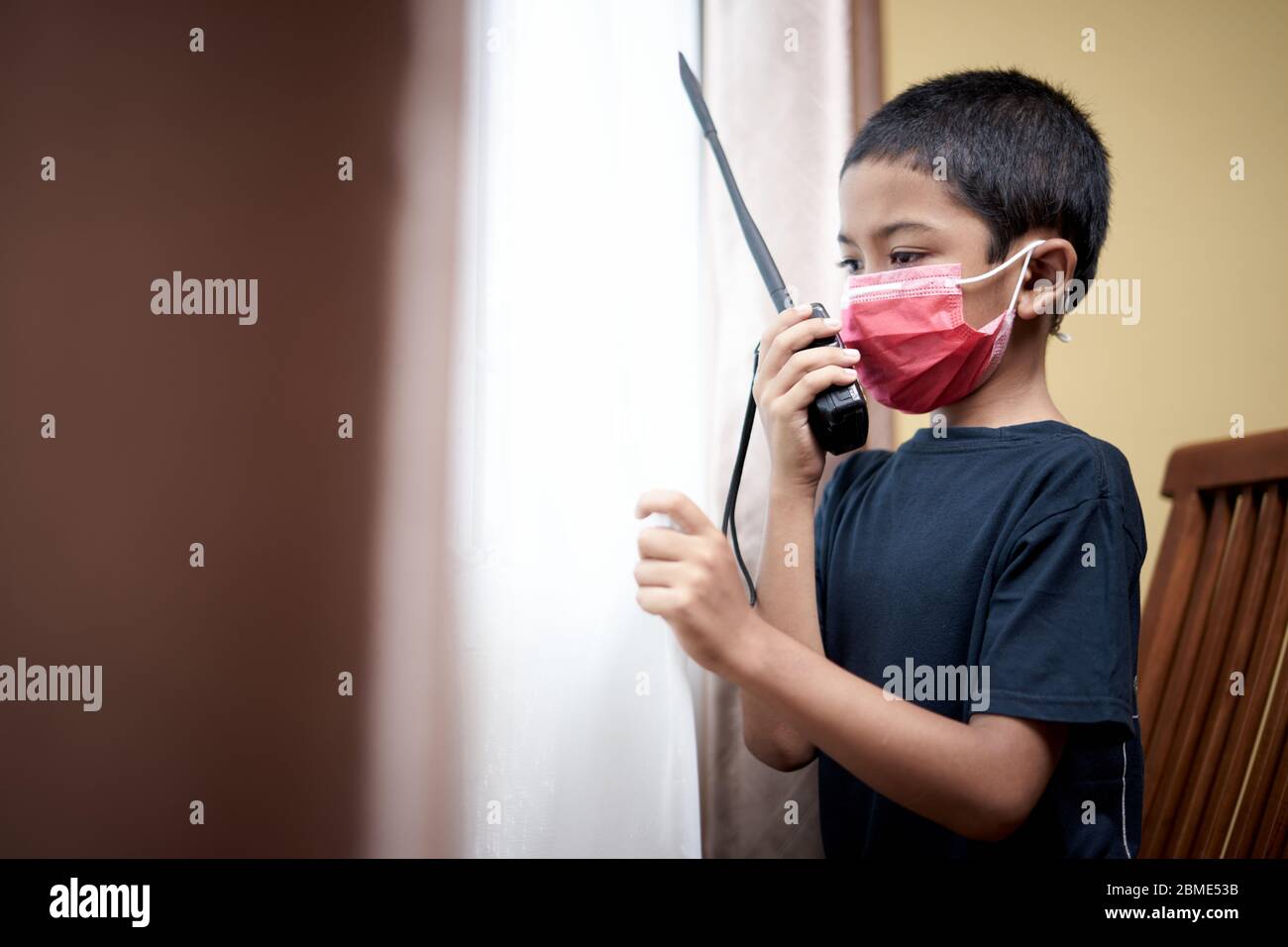 Sad little Boy communicate using walkie talkie and looking through ...