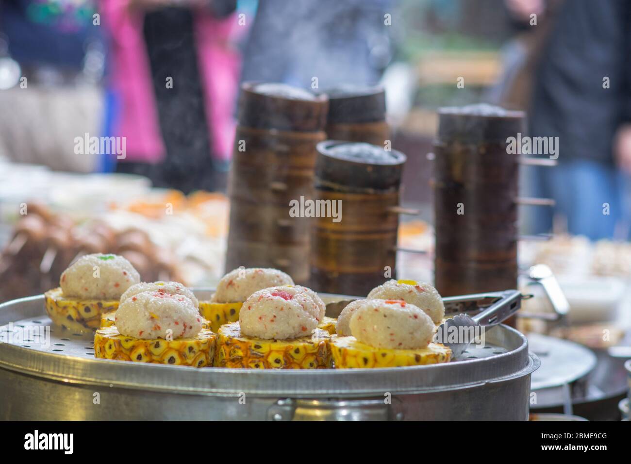 Chinese dessert, steamed rice balls on slices of fresh pineapple Stock ...