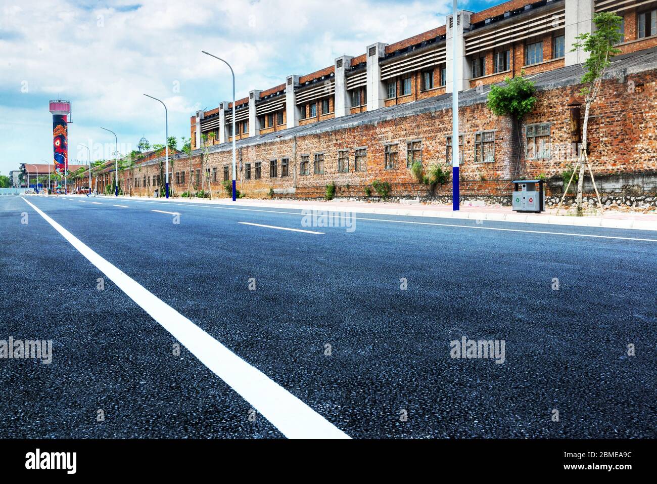 Asphalt road straight ahead outdoors in old industrial area Stock Photo ...