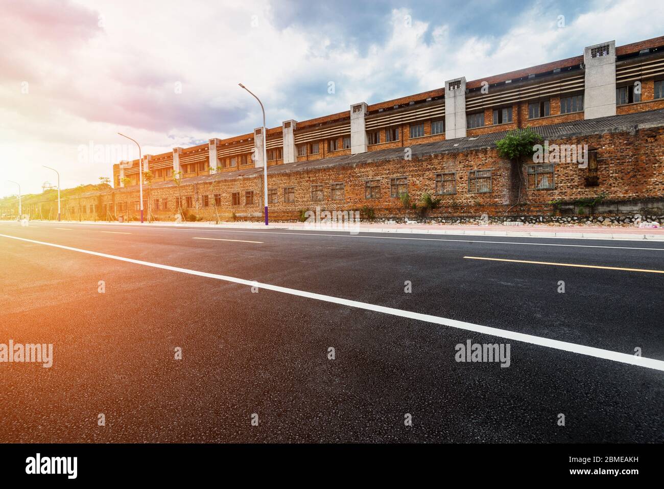Asphalt road straight ahead outdoors in old industrial area Stock Photo ...