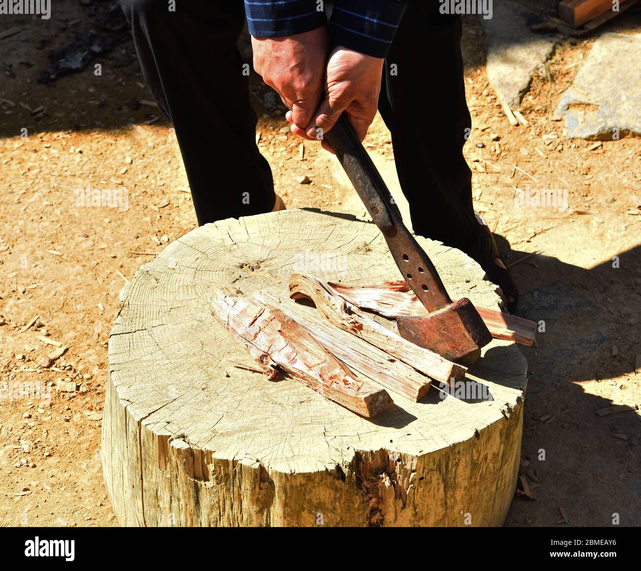 man choping log with an axe Stock Photo - Alamy