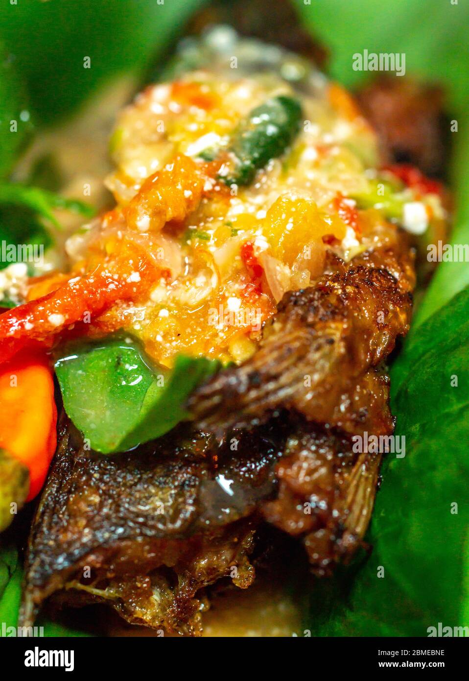 Botok lele, fried catfish served with spicy curry and wrapped with ...