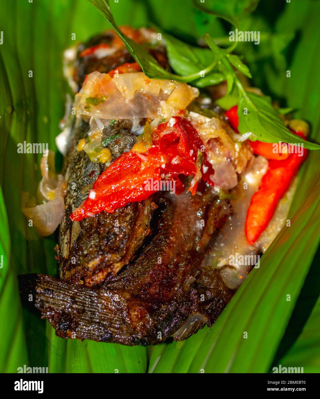 Botok lele, fried catfish served with spicy curry and wrapped with ...