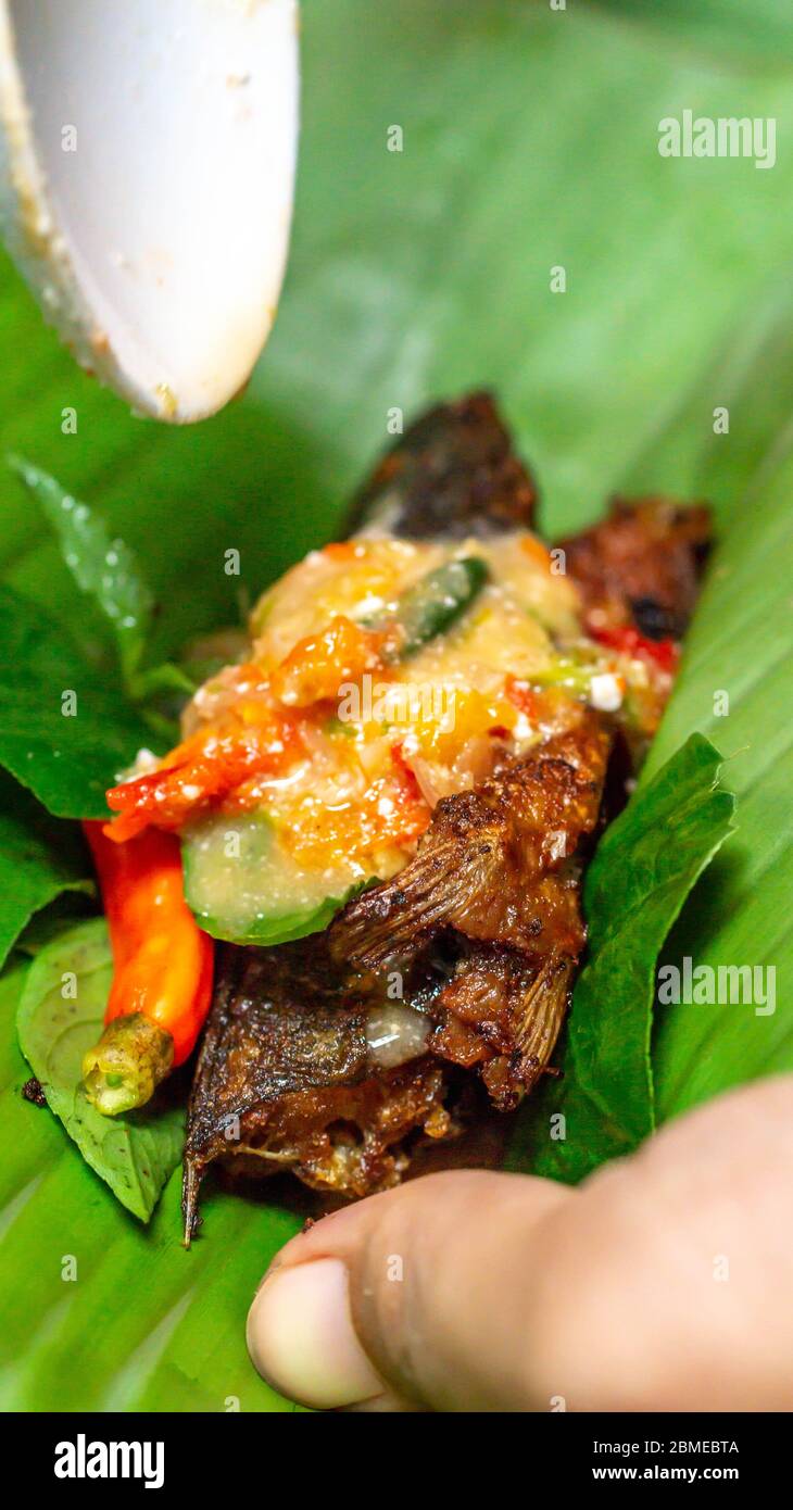Botok lele, fried catfish served with spicy curry and wrapped with ...