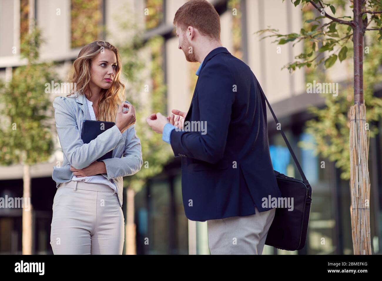 Young business people talking together and standing outdoors Stock ...