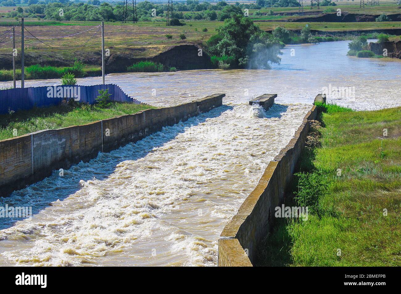 Small dam with water flowing rapids. Seen as lines and patterns with ...
