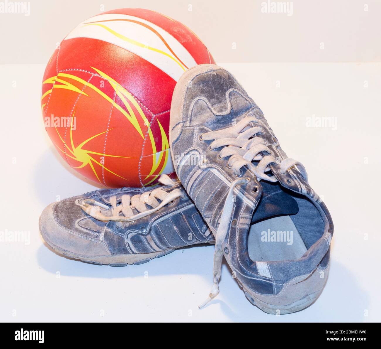 very old running shoes with laces on a light background Stock Photo - Alamy