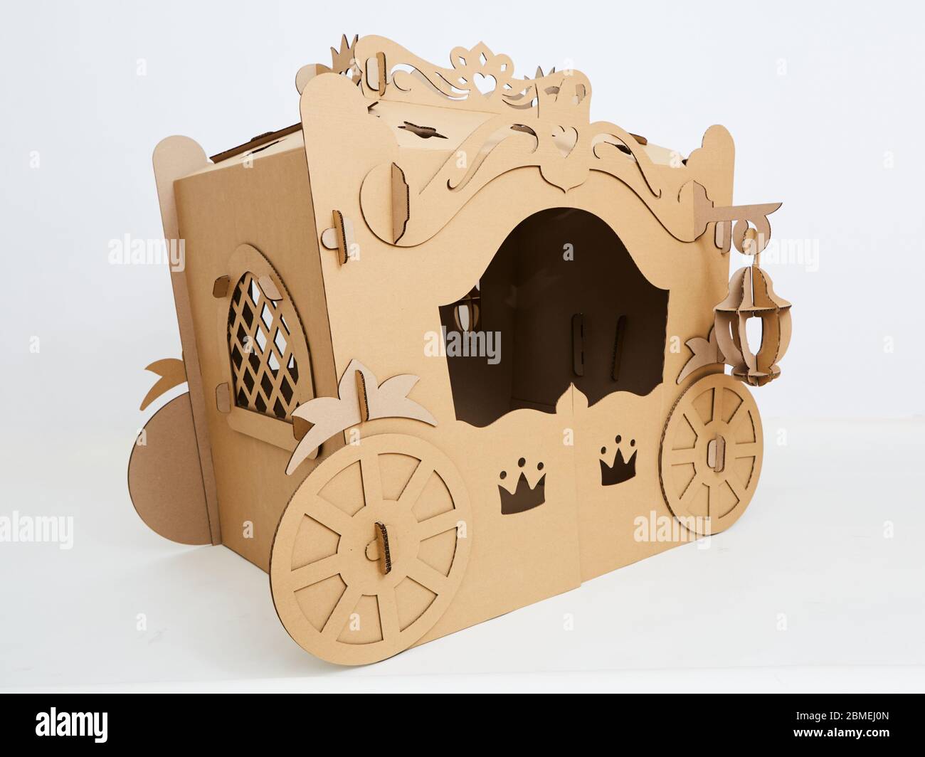 A horse and a carriage made of brown cardboard,where the horse is ...
