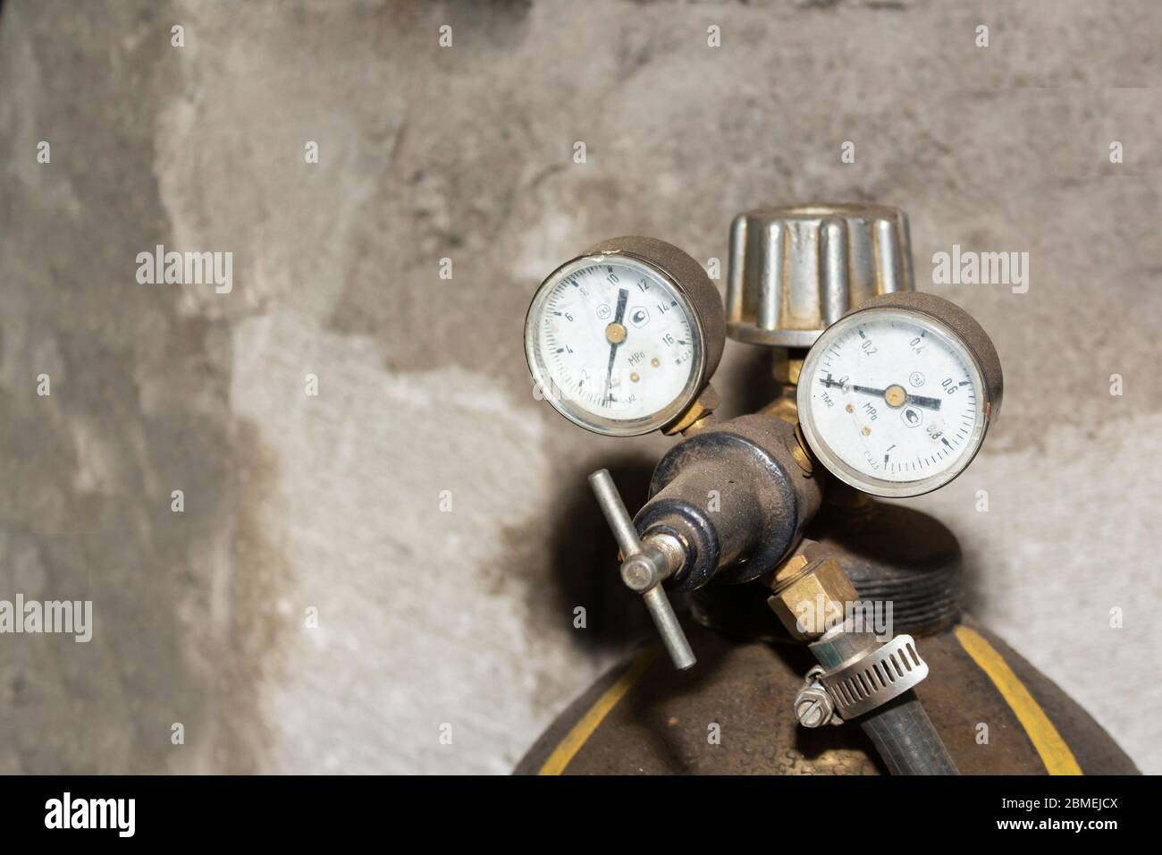 Close-up of a metal gas cylinder with a reducer and a pressure sensor ...