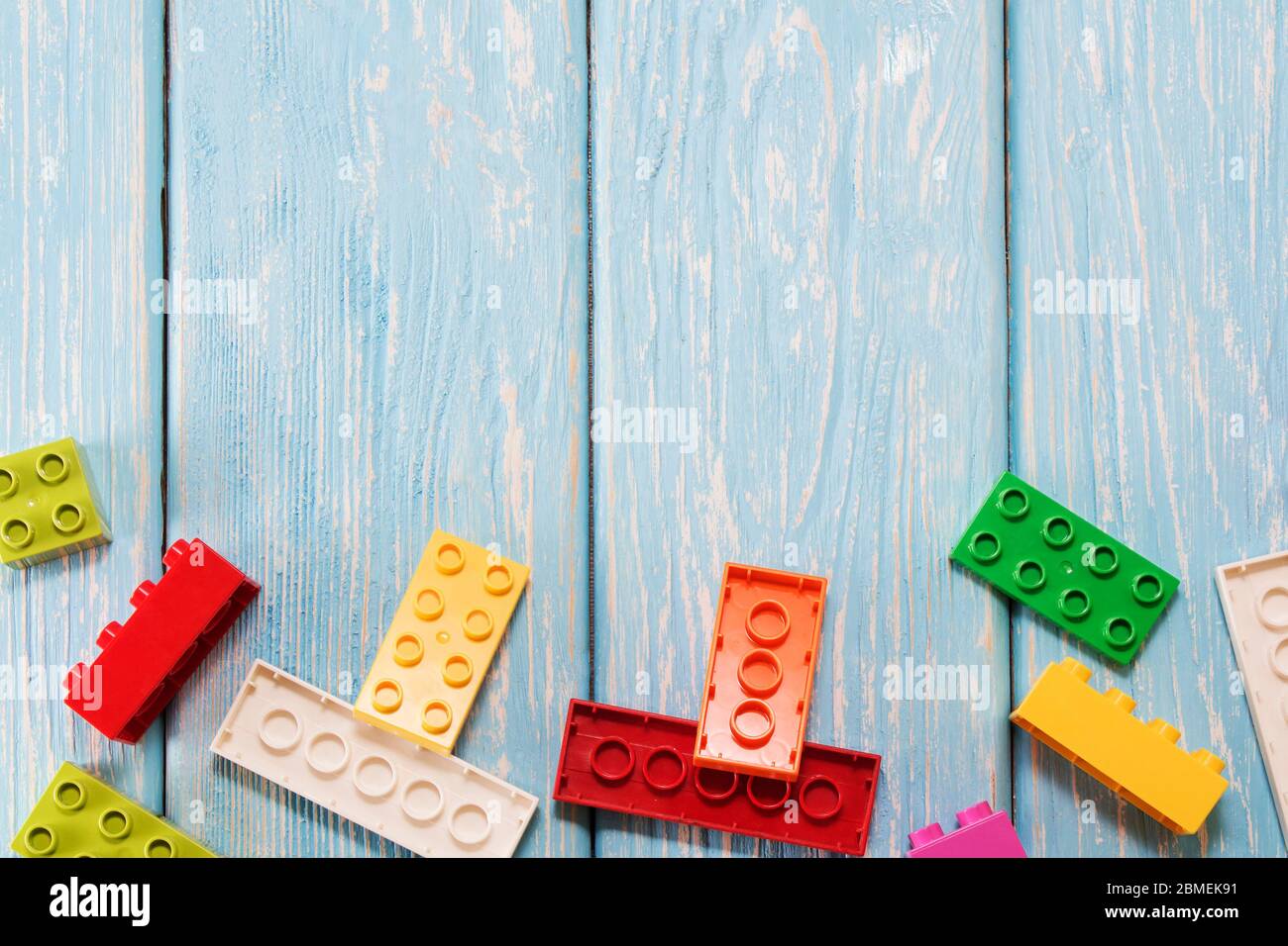 Multicolored plastic building blocks of the designer. Background of ...