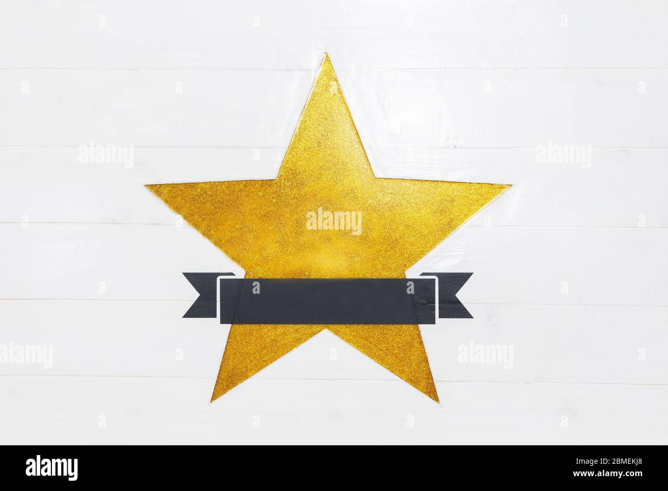 bright yellow star on a wooden white background with space for ...