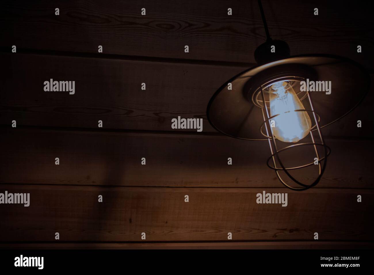 Old fashioned vintage lantern lamp burning with a soft glow light in an ...