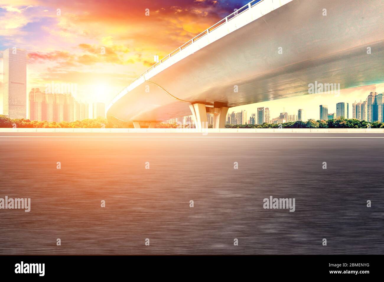 Under the overpass, car-free asphalt road, modern city building skyline ...