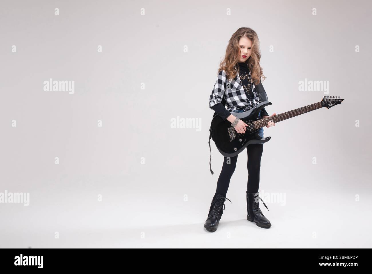 Cute baby girl rock star playing electric guitar and singing song ...