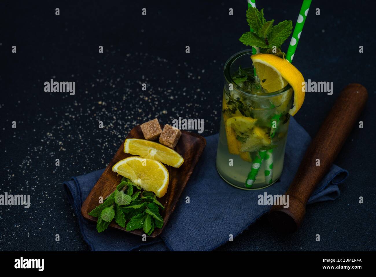 Tasty gin and tonic cocktail with slices of lemon and fresh mint on ...