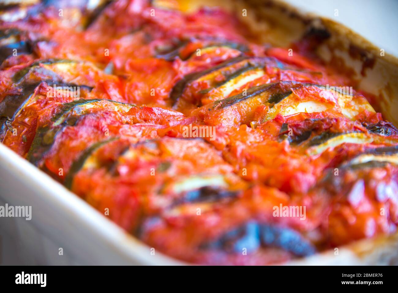 Homemade ratatouille made with sliced vegetables: zucchini, tomatoes ...