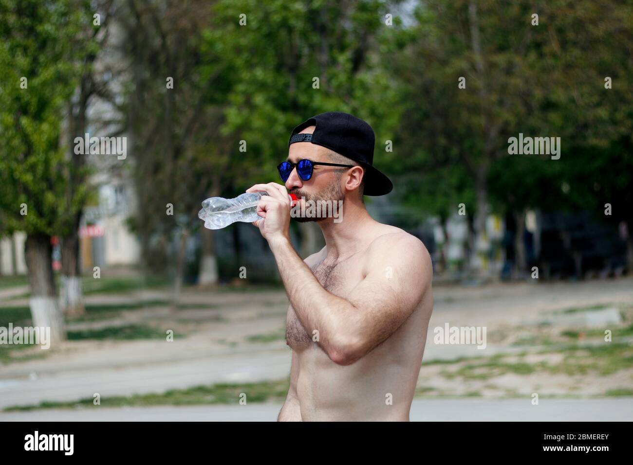 strong young man drinking water after exercises outdoor Stock Photo - Alamy
