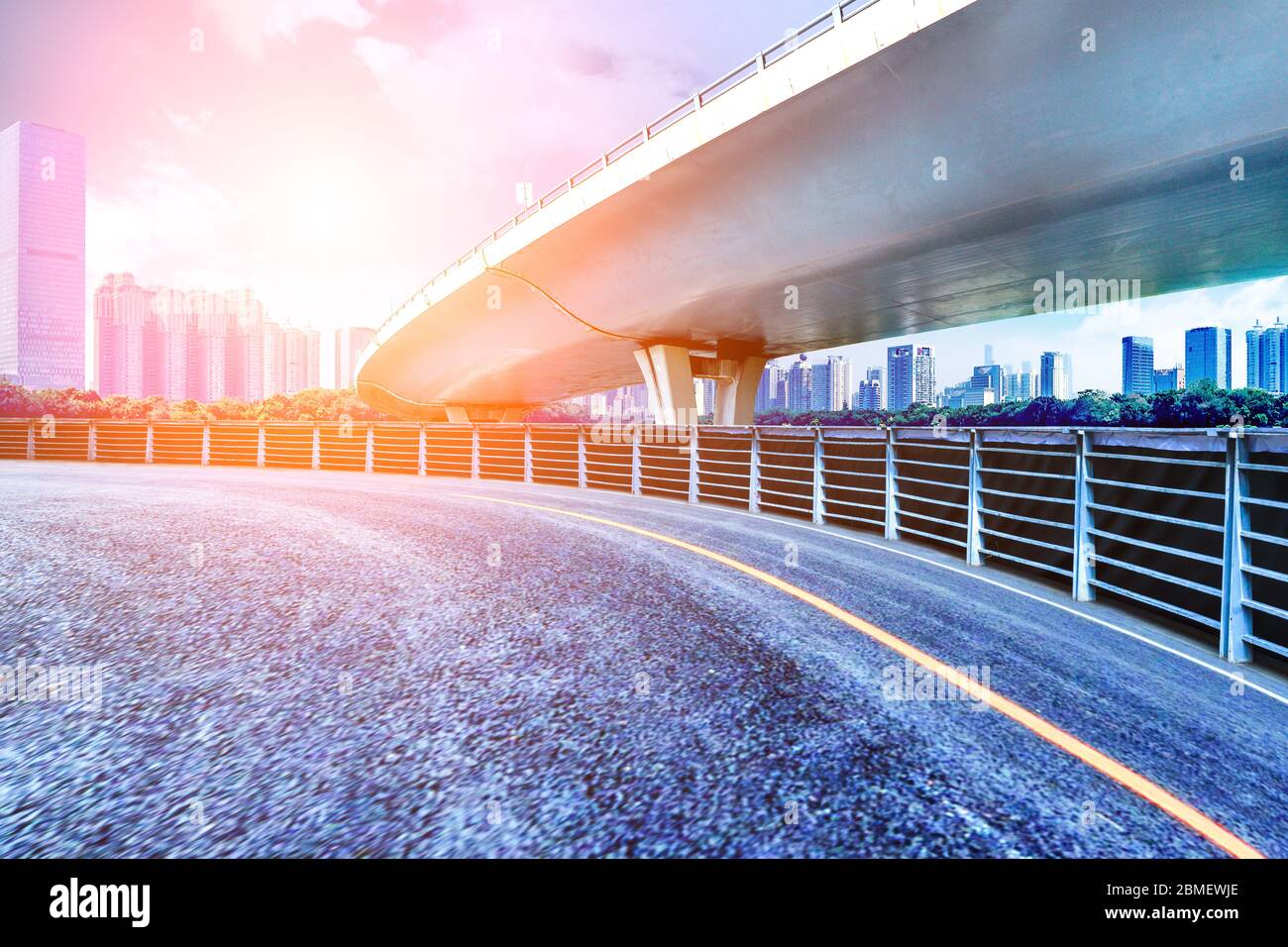 Under the overpass, car-free asphalt roads, modern city buildings as ...