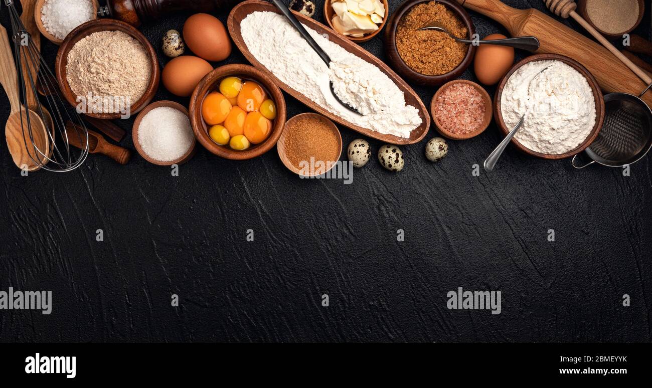 Baking ingredients on black background, top view Stock Photo - Alamy