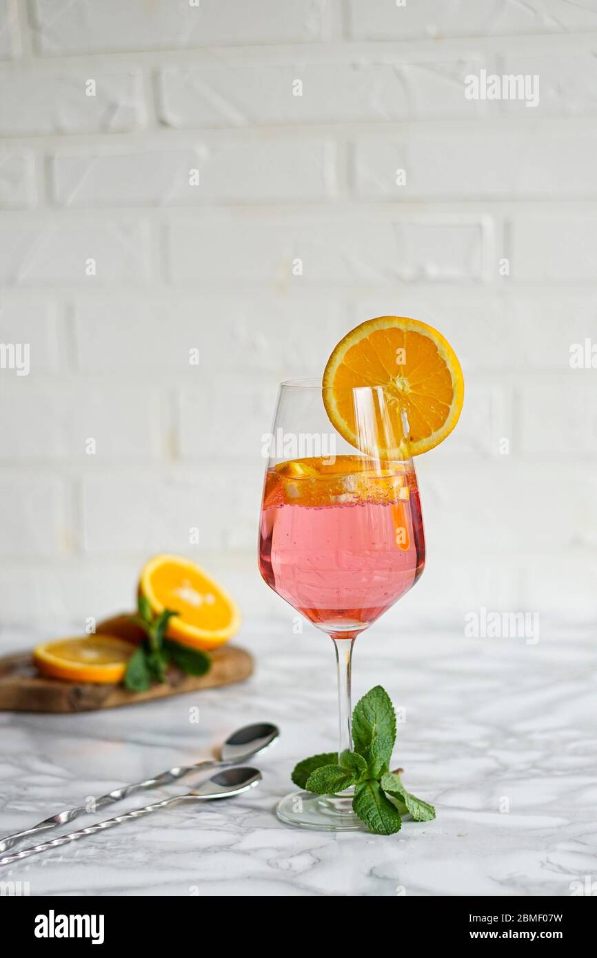 alcoholic drink with champagne and orange, pink color. aperol syringe ...