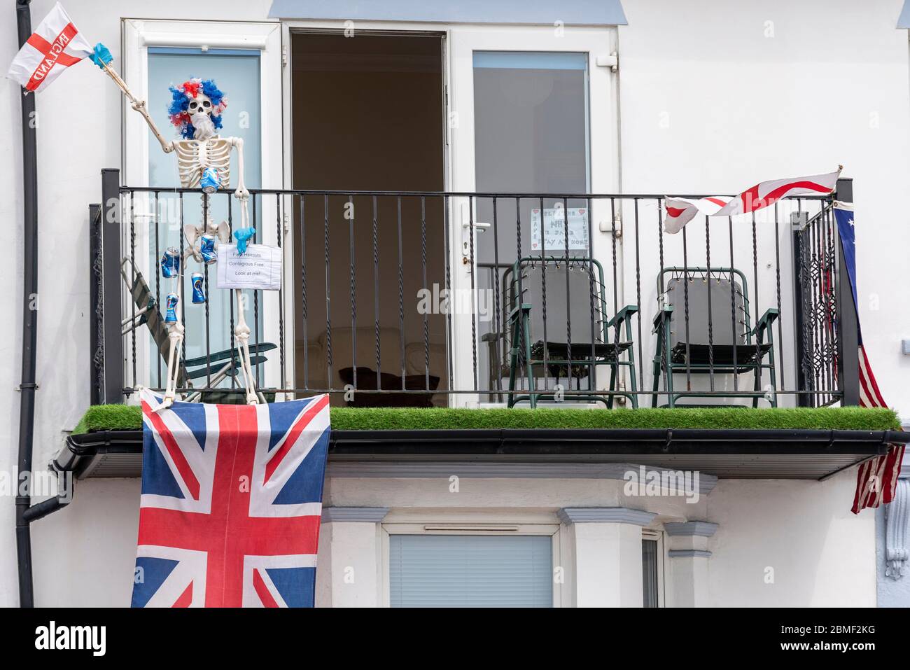 A skeleton in red, white and blue coloured wig, waving an England flag ...