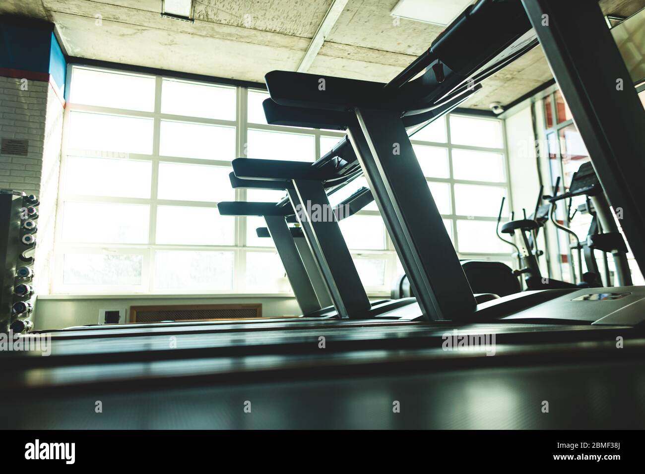 Running simulators in the gym interior opposite the window. Empty ...